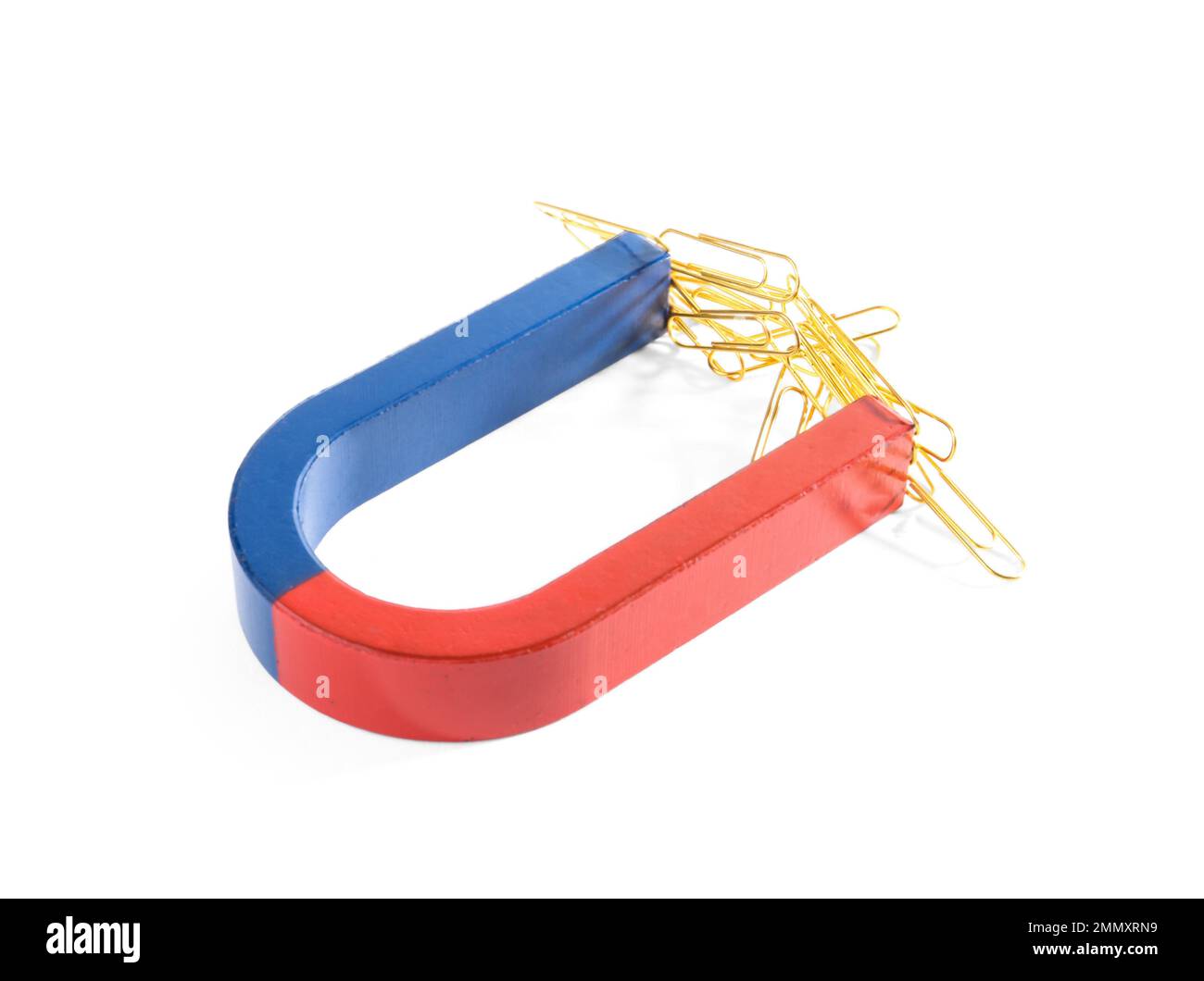 Magnet attracting paper clips on white background Stock Photo - Alamy