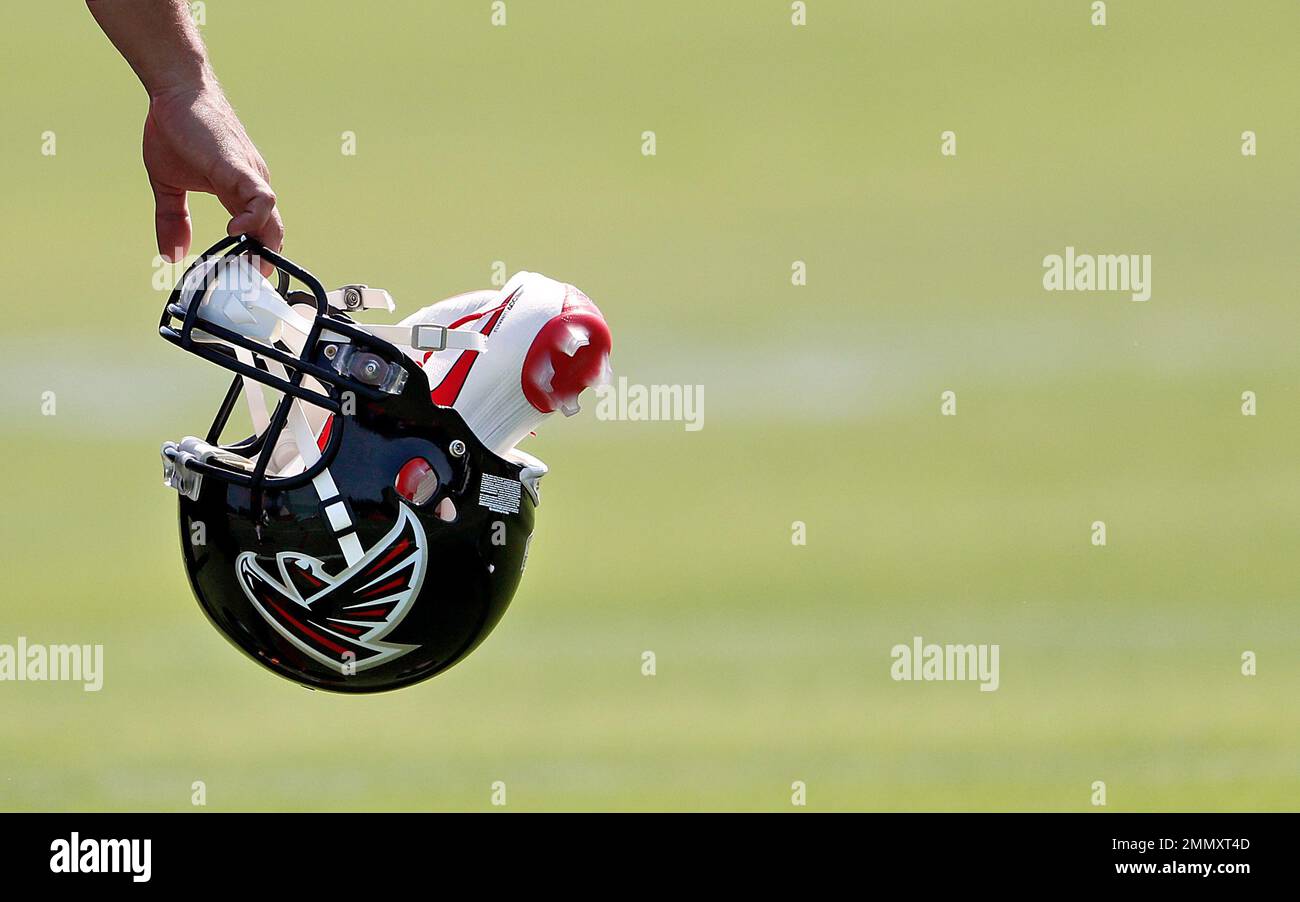 Atlanta Falcons punter Matt Bosher carries his cleats in his helmet ...