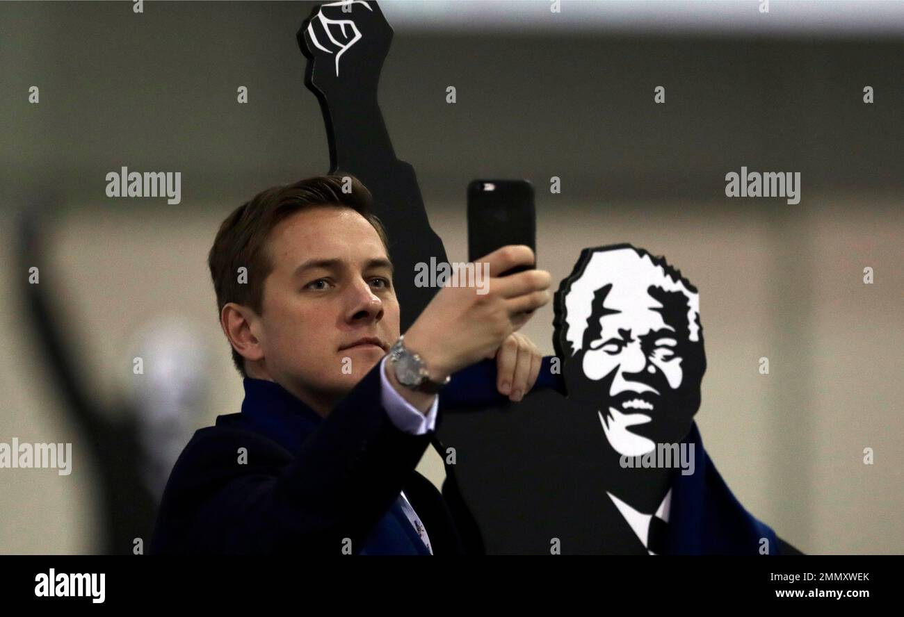 A journalist takes a selfie with a placard of Nelson Mandela during the ...