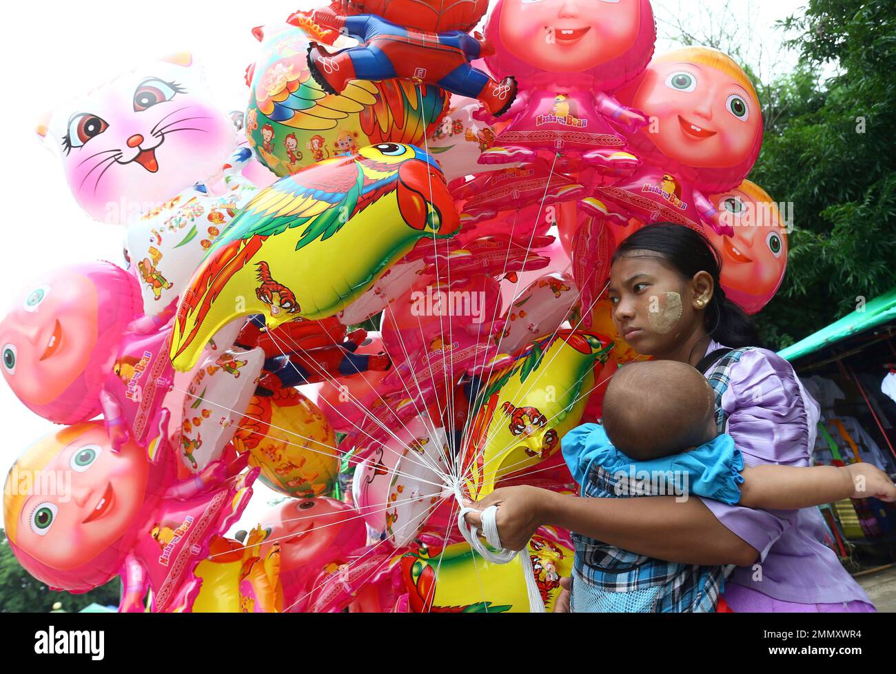A Myanmar balloon vendor waits for customers outside Uppatasanti Pagoda ...