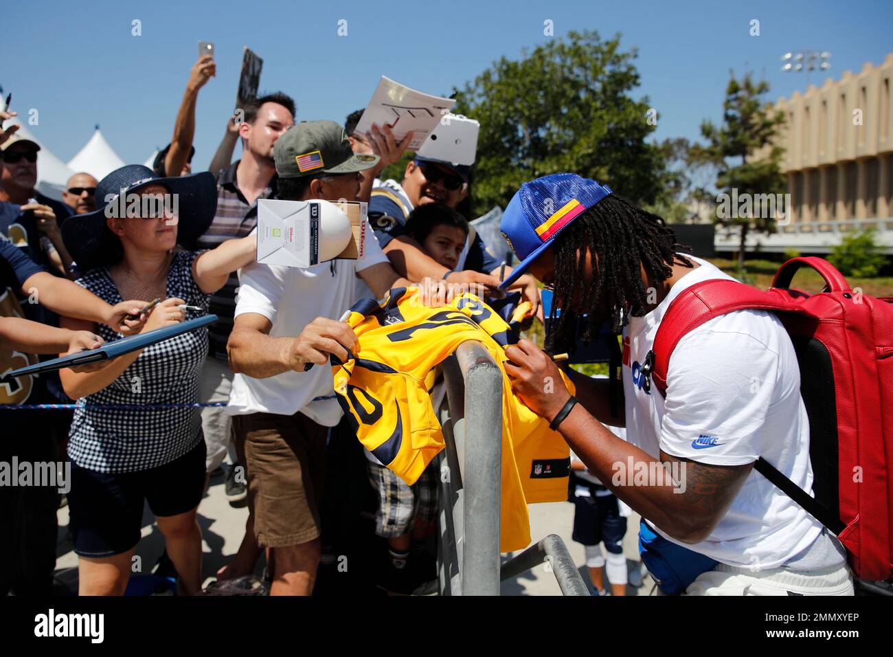 Los Angeles Rams running back Todd Gurley, right, signs autographs as ...