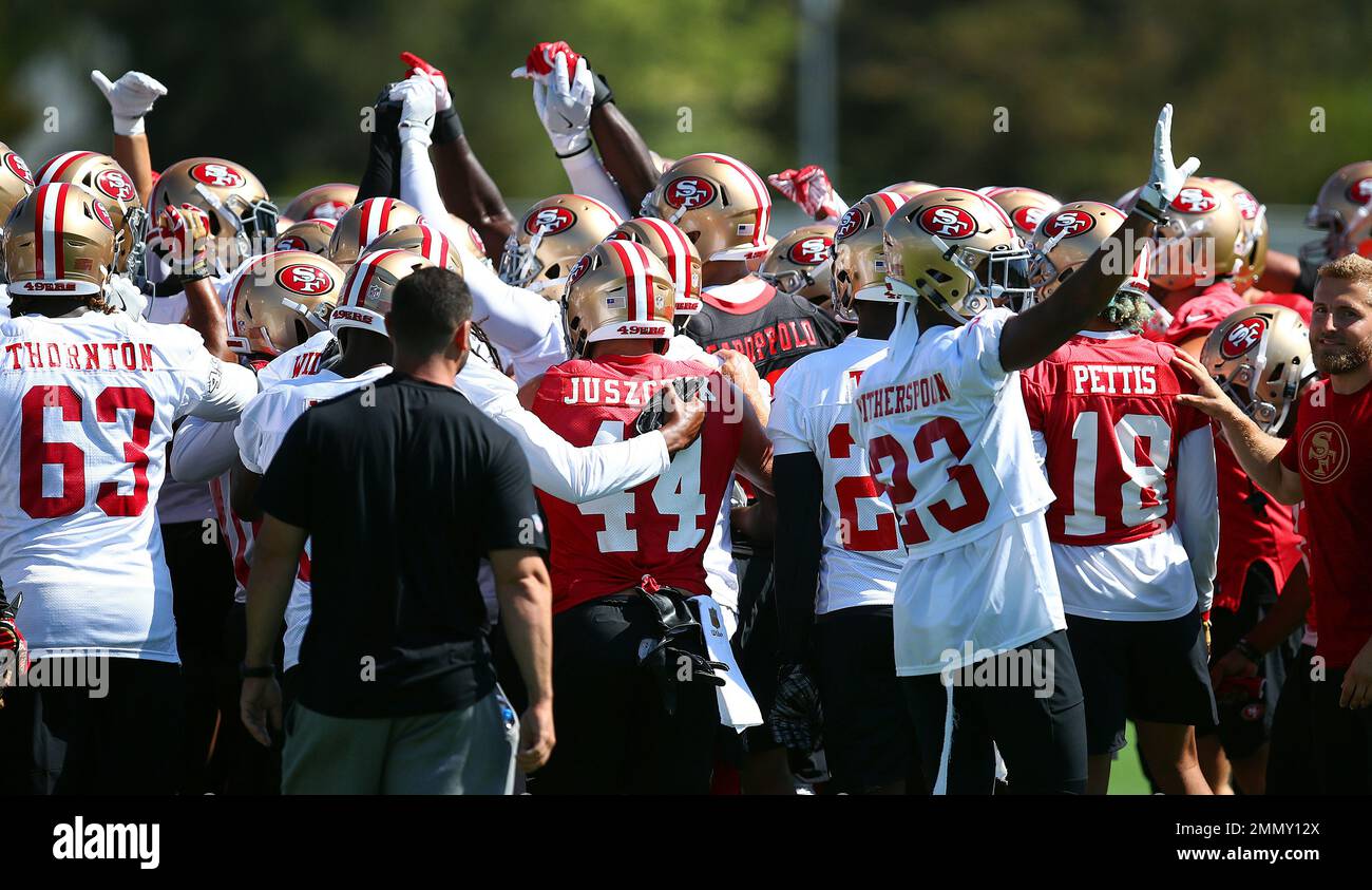 San Francisco 49ers huddle during NFL football practice at the team's ...