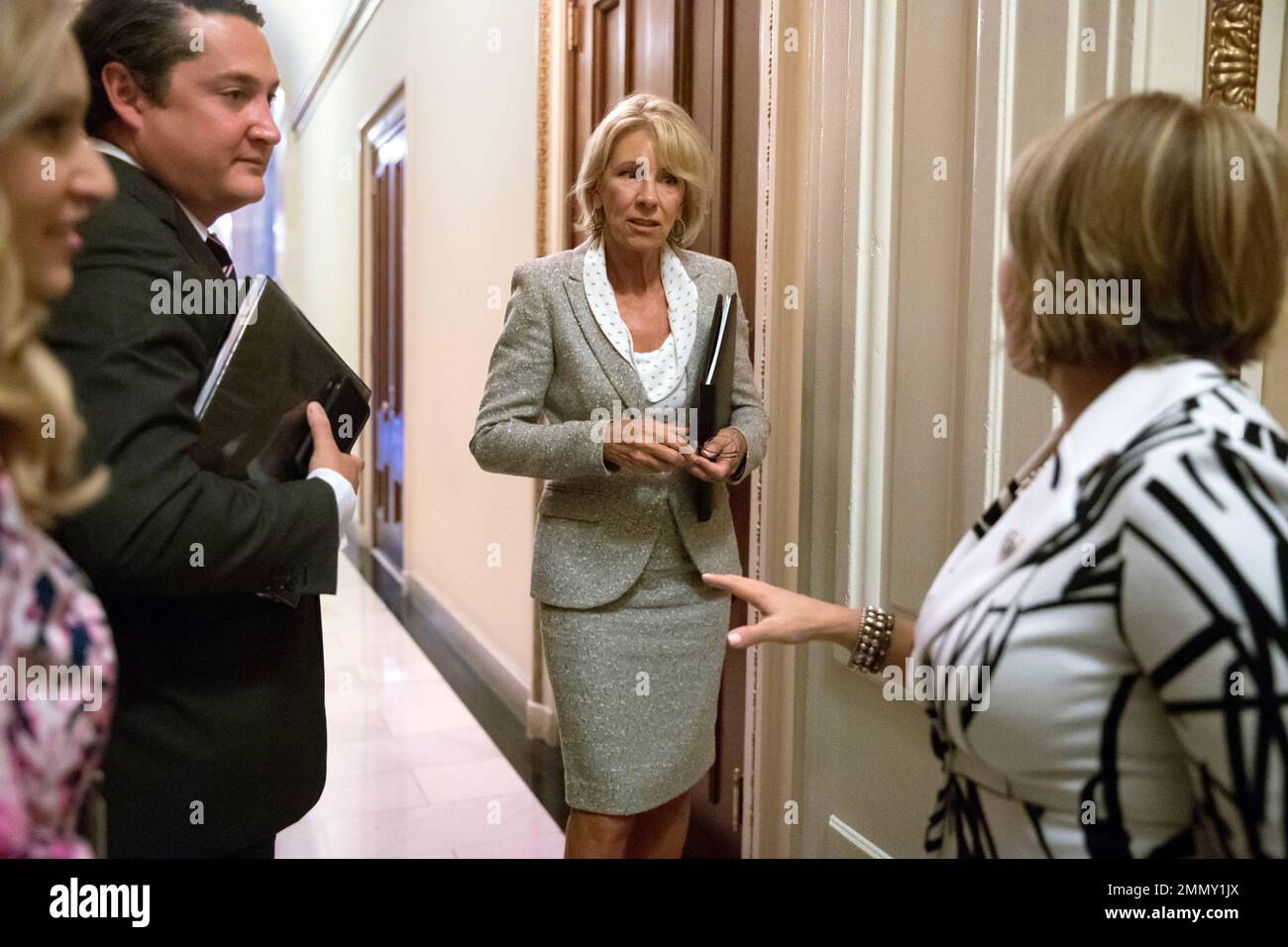Education Secretary Betsy DeVos, center, has a final word with Hispanic ...
