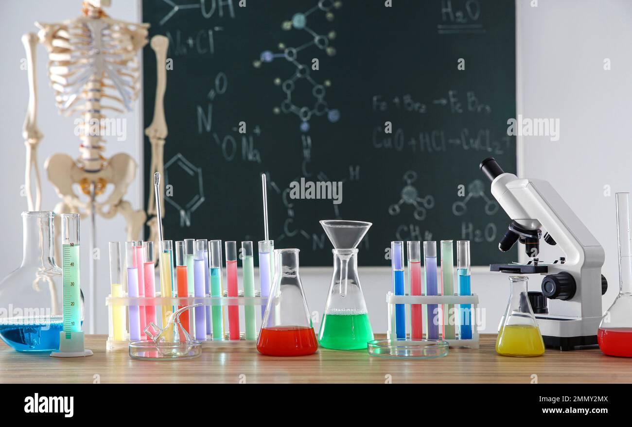 Different chemistry glassware on table in classroom Stock Photo - Alamy