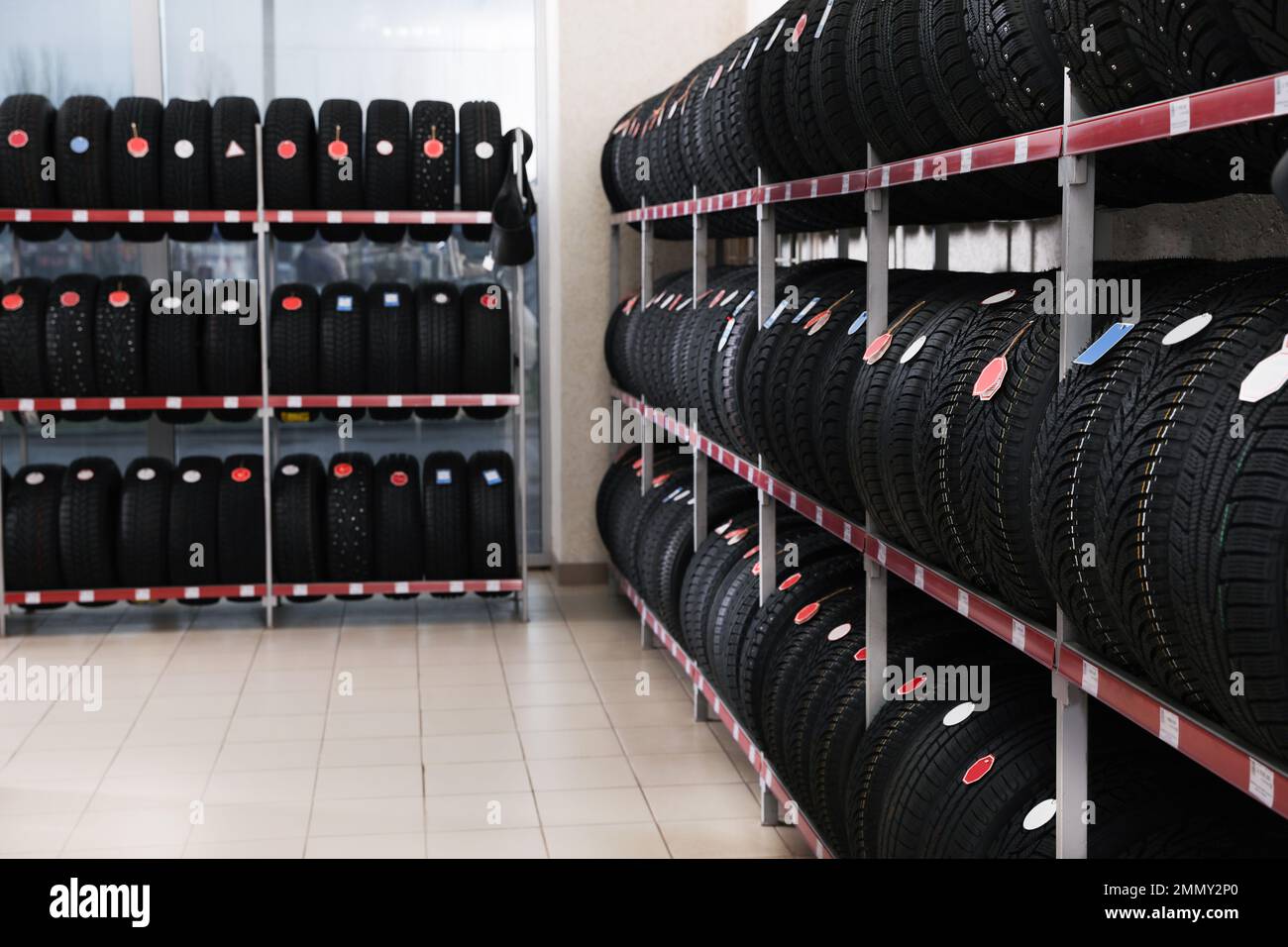 Car tires on rack in auto store Stock Photo - Alamy