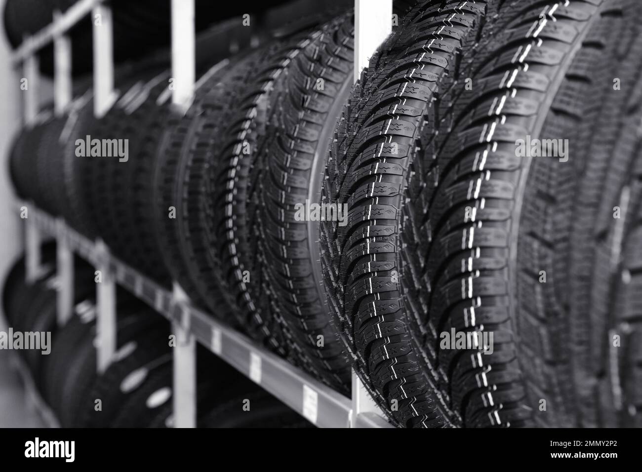 Car tires on rack in auto store, closeup Stock Photo - Alamy