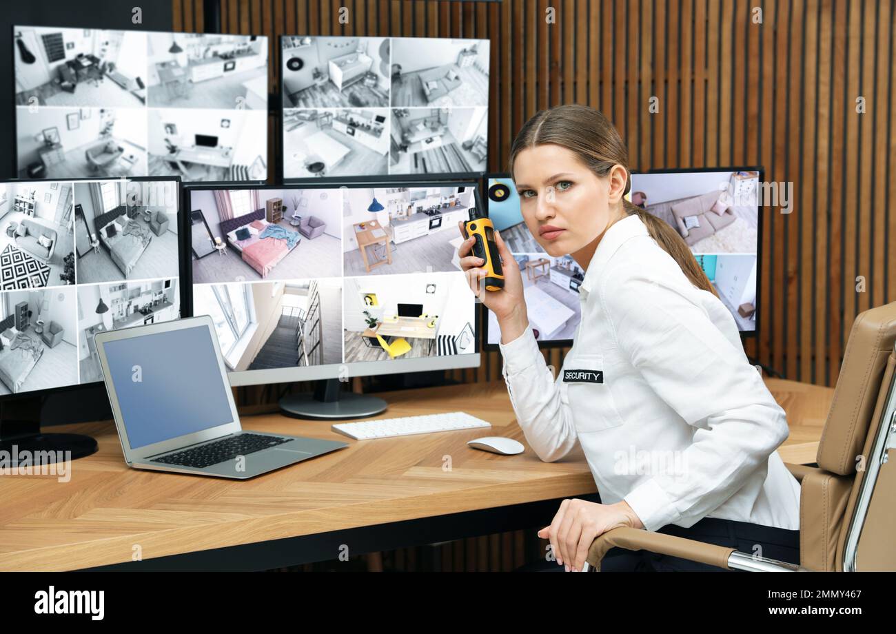 Security guard using portable transmitter at workplace Stock Photo - Alamy