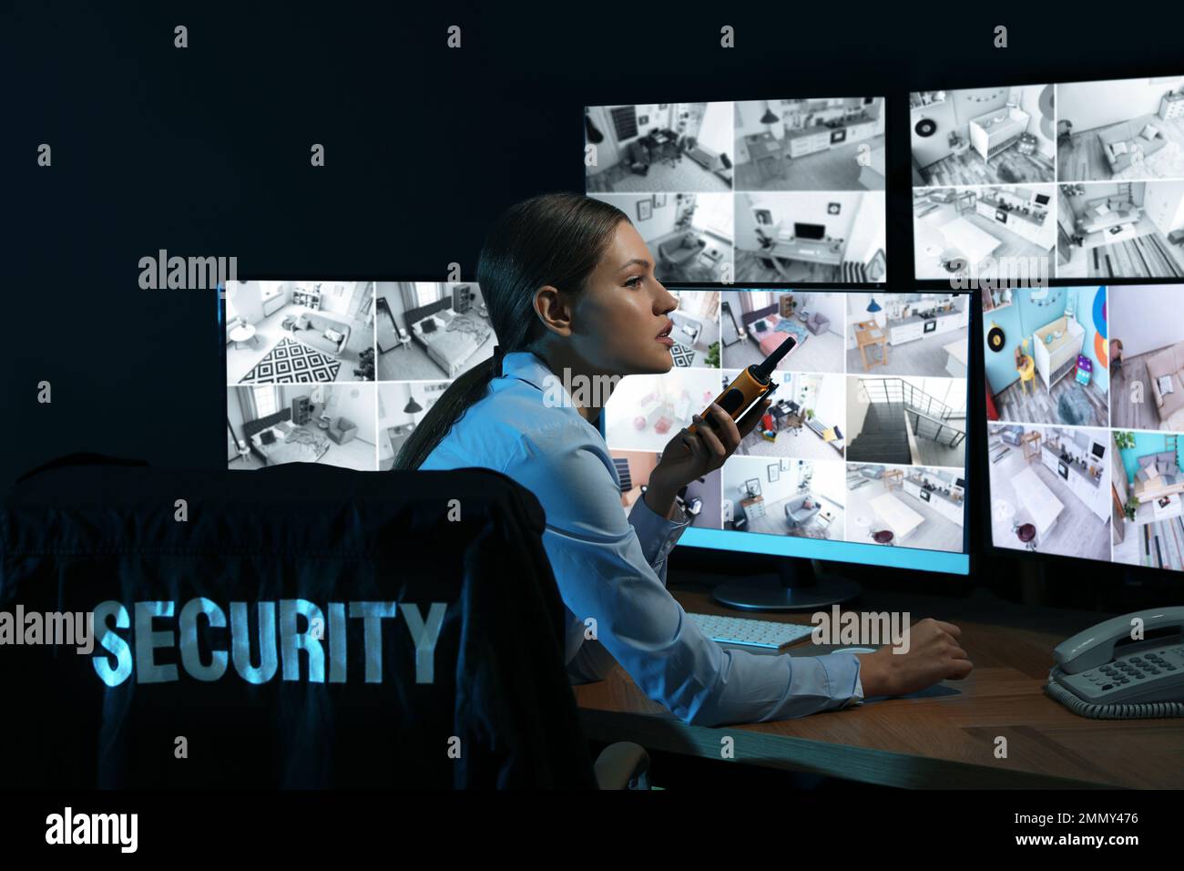 Security guard with portable transmitter monitoring modern CCTV cameras ...