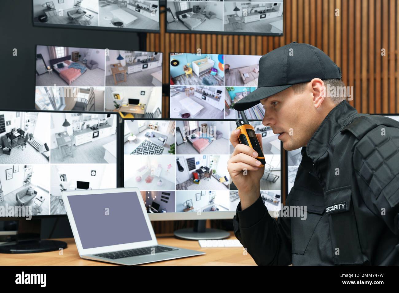 Security guard using portable transmitter at workplace in office Stock ...