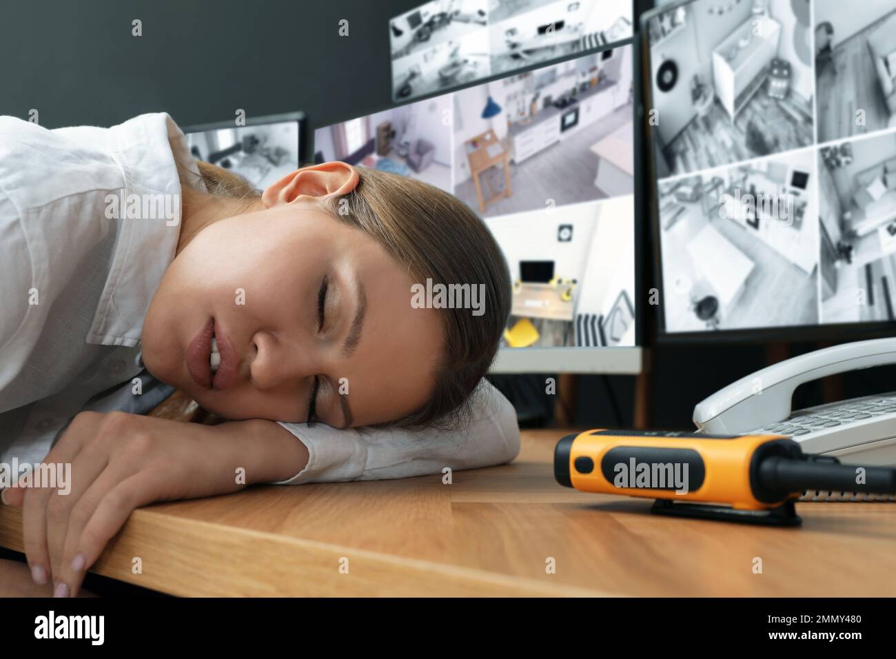 Tired security guard sleeping at workplace in office Stock Photo - Alamy
