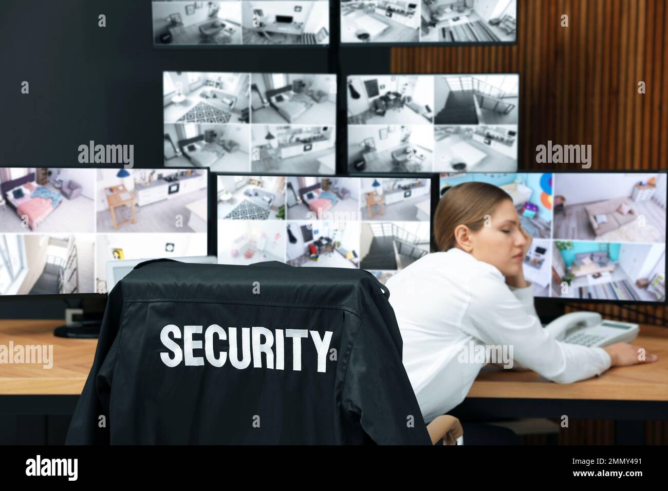Tired security guard sleeping at workplace in office Stock Photo - Alamy