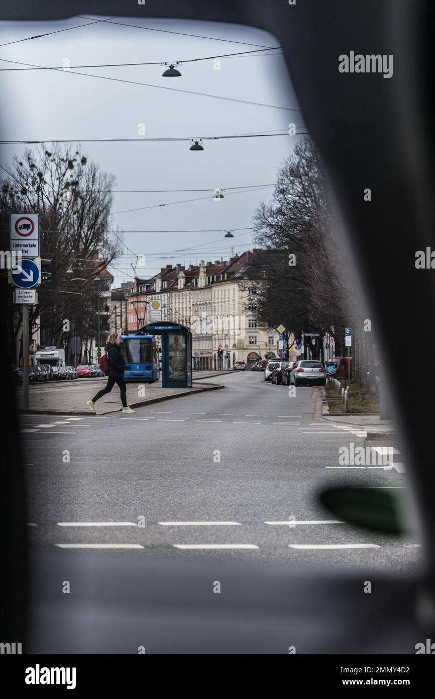 Lady crossing the road Stock Photo - Alamy