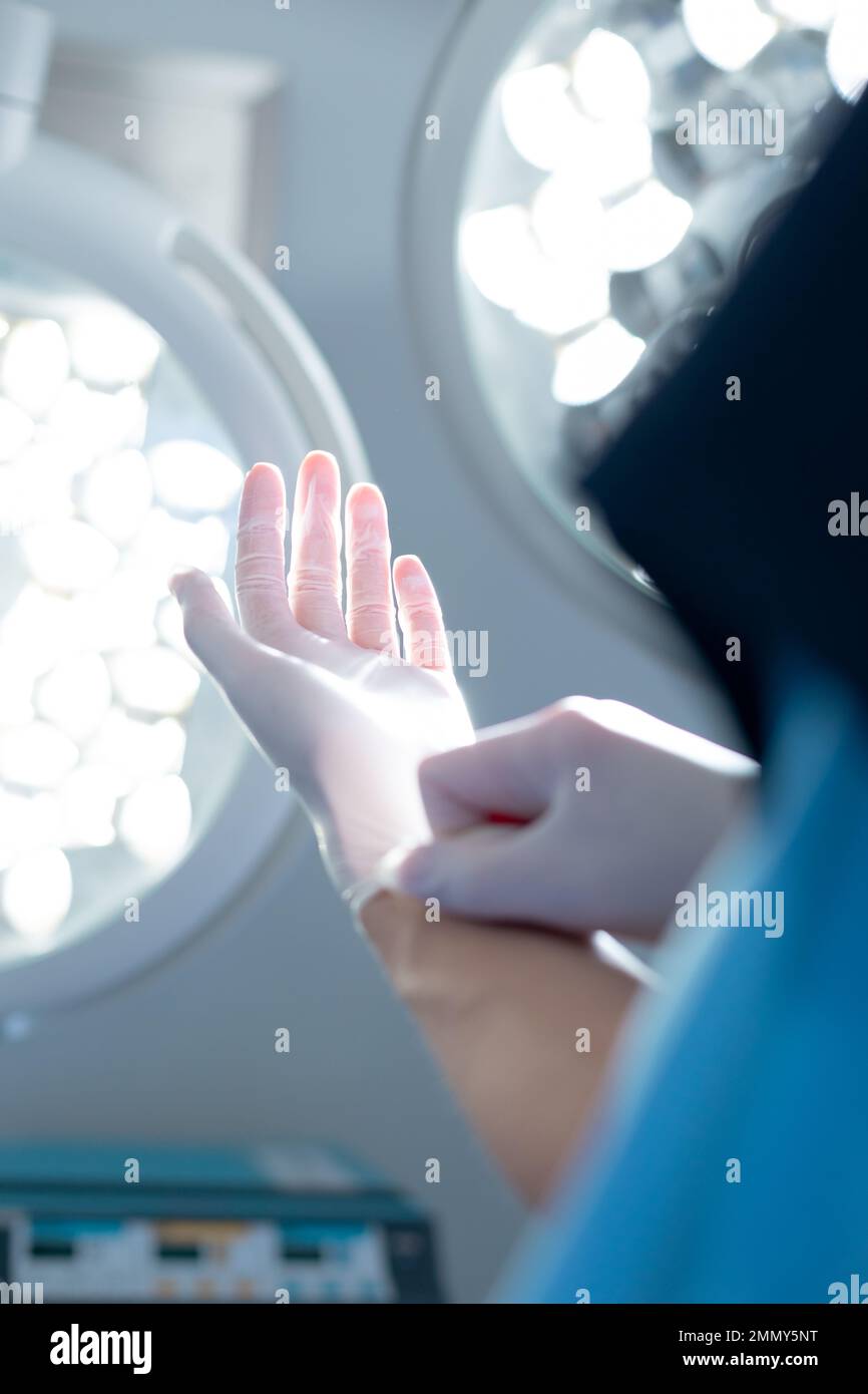 Caucasian female surgeon in an operating theatre, wearing medical ...