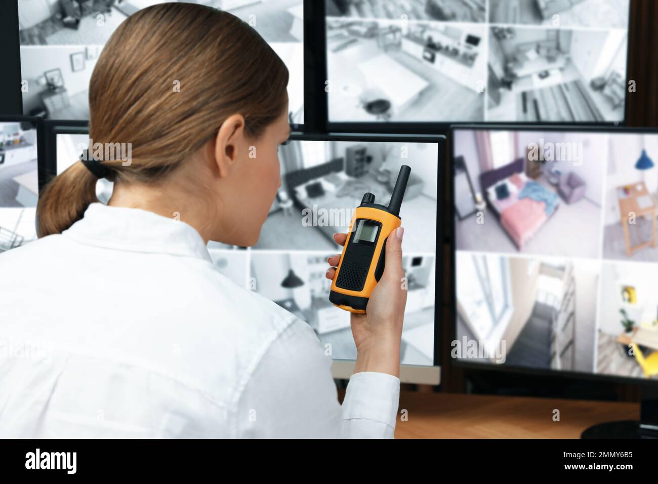 Security guard using portable transmitter at workplace Stock Photo - Alamy