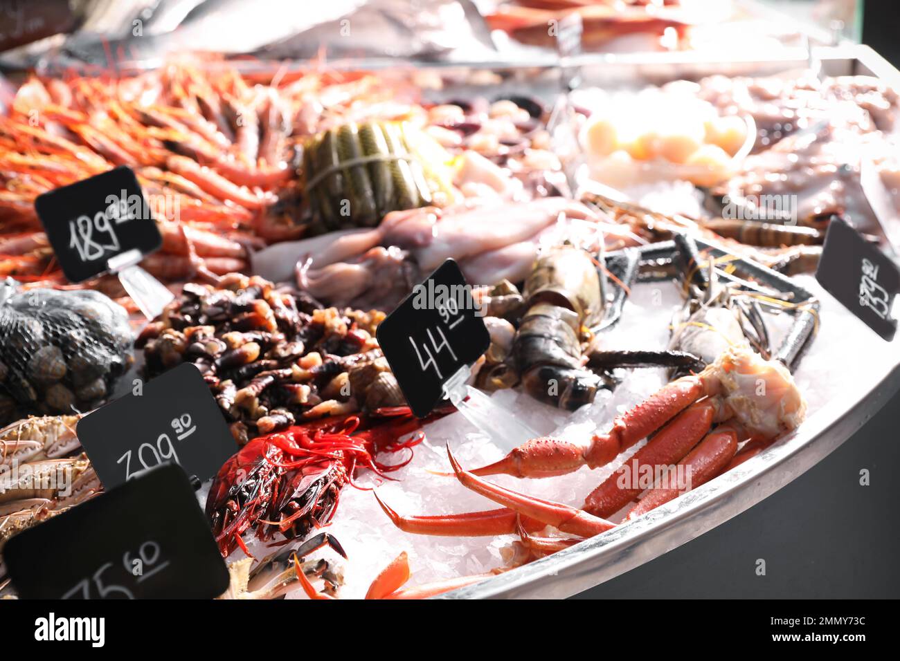 Different types of fresh seafood on ice in supermarket Stock Photo - Alamy