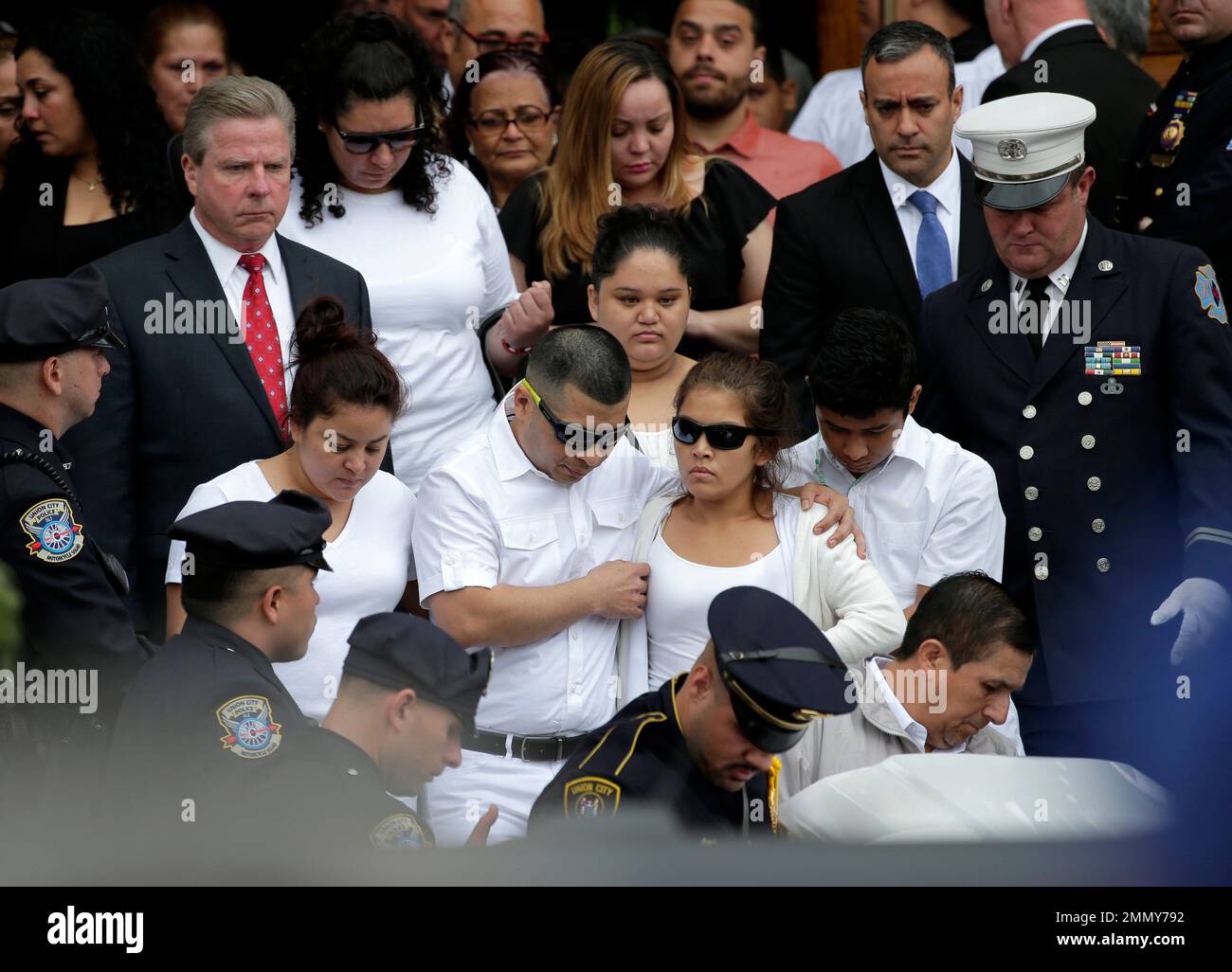 Friends and family follow five caskets out of the church during the ...