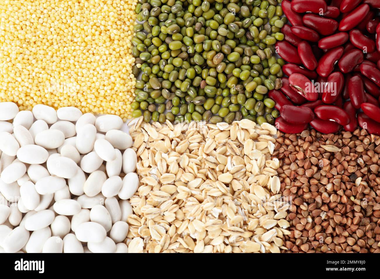 Different grains and cereals as background, top view Stock Photo - Alamy