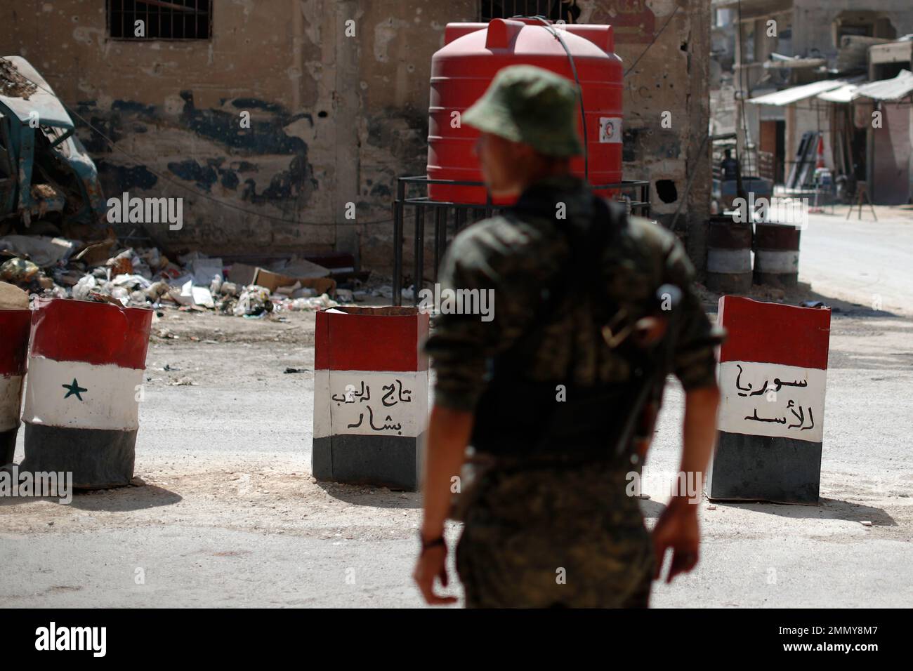 In this Sunday, July 15, 2018, photo, a Syrian soldier stands guard in ...