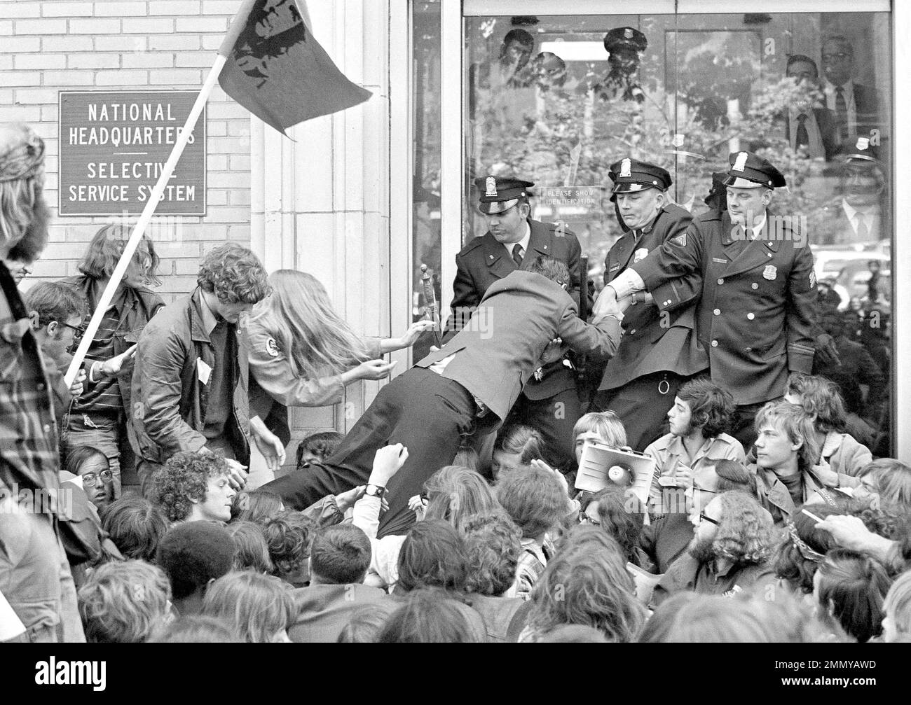 Police pull an employee of the Selective Service System across ...