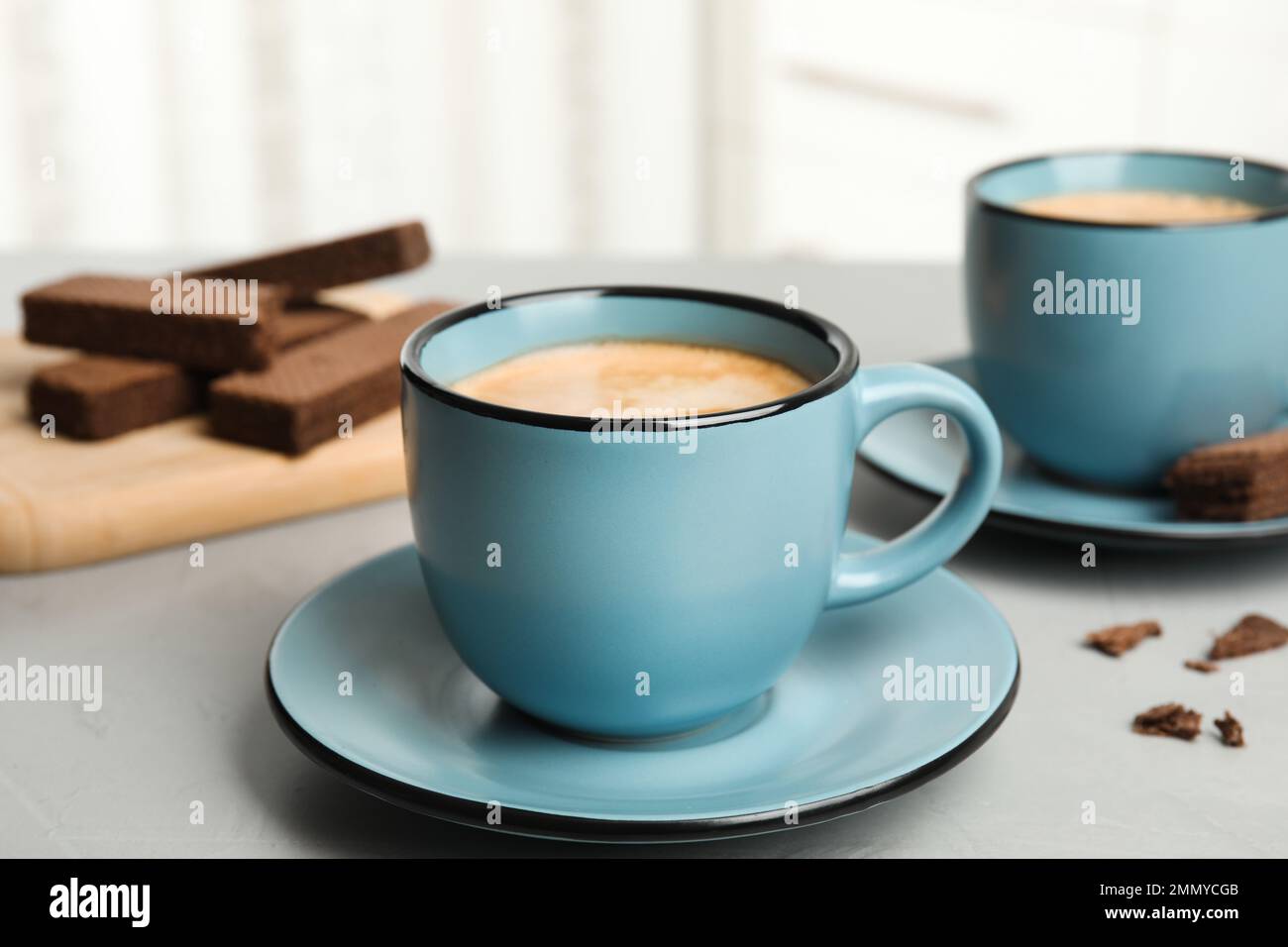 Delicious coffee and wafers for breakfast on grey table Stock Photo - Alamy