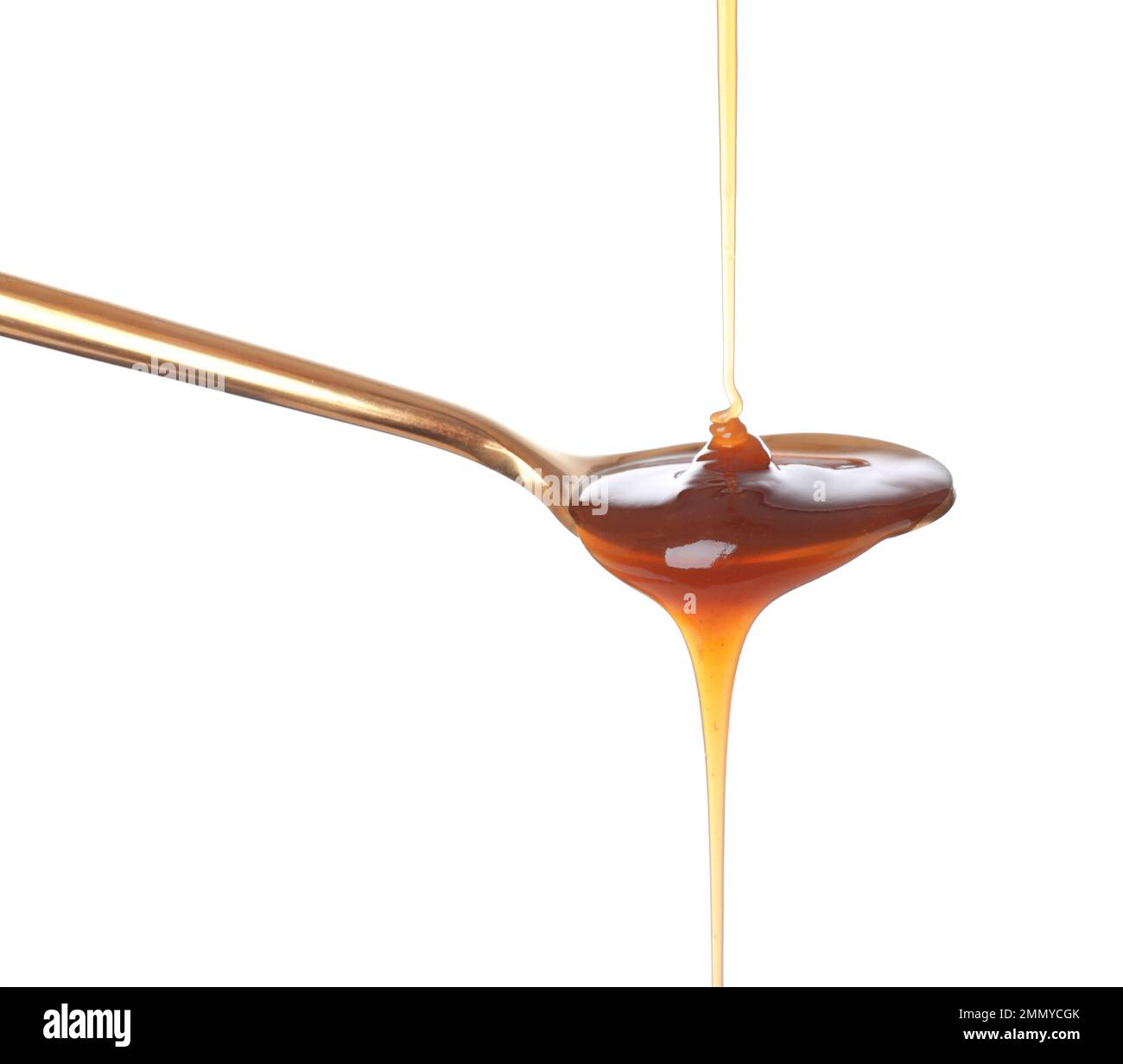 Pouring salted caramel into spoon isolated on white Stock Photo - Alamy
