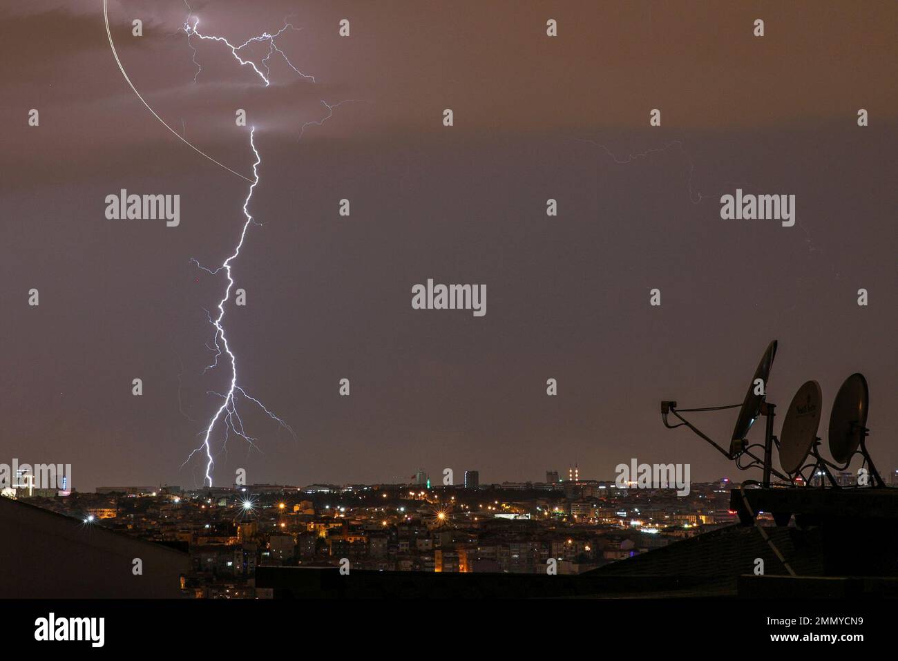 Lightning flashes in the distance as a thunderstorm passes during a ...
