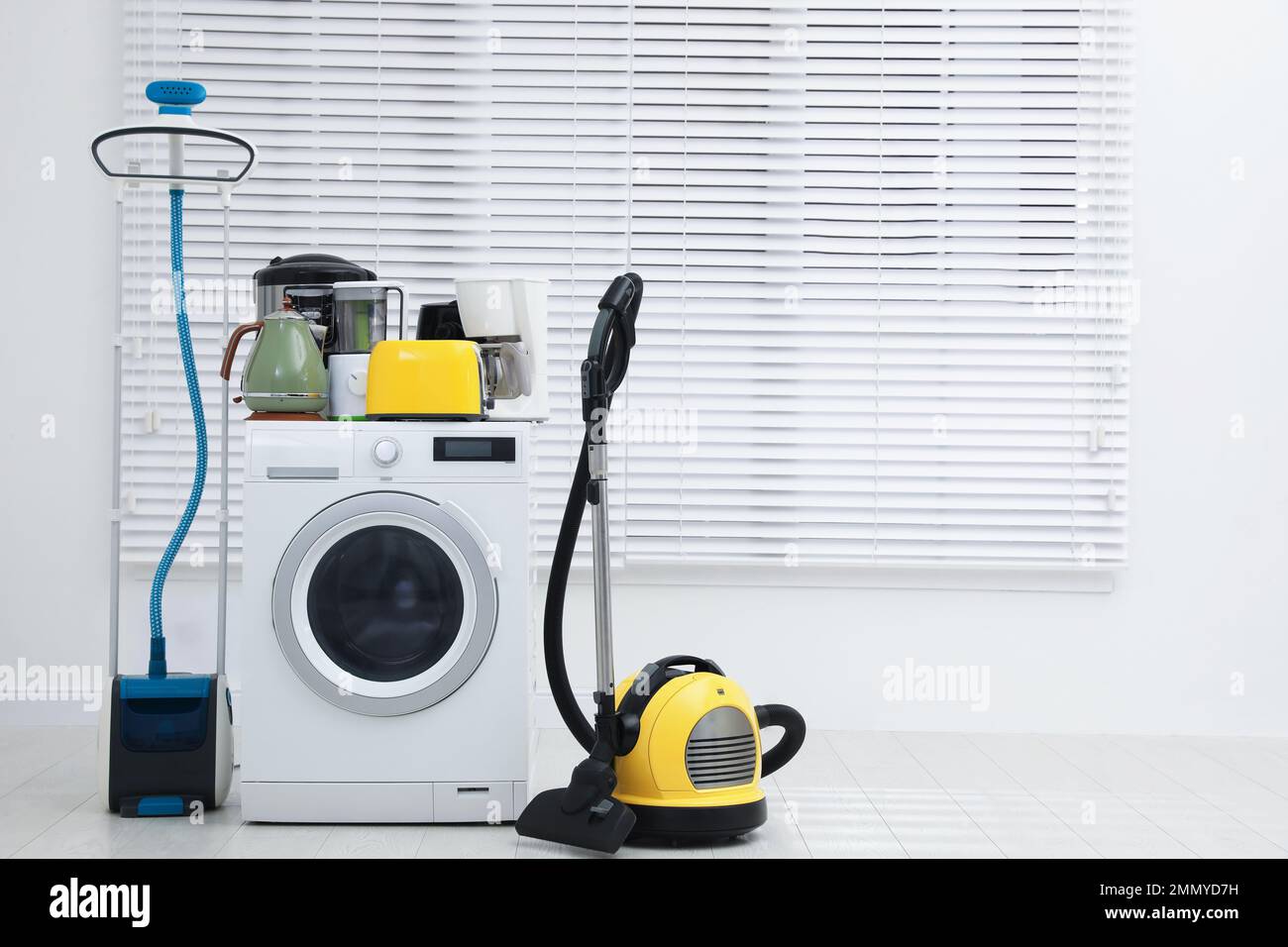 Different household appliances near window in room. Space for text ...