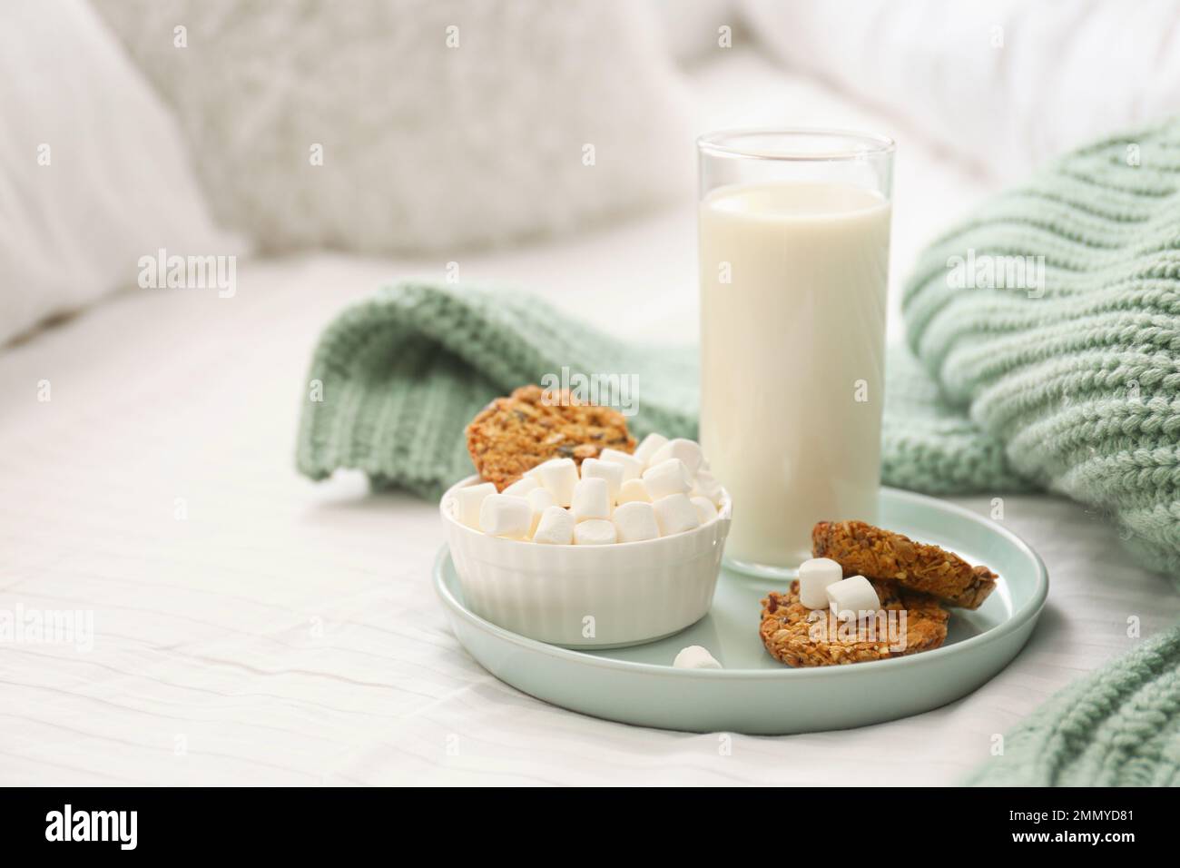 Cookies, marshmallows and milk on bed. Delicious morning meal Stock ...