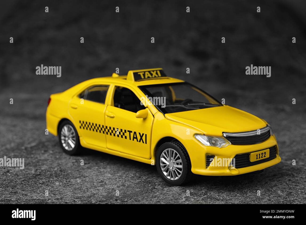 Yellow taxi car model on grey background Stock Photo - Alamy