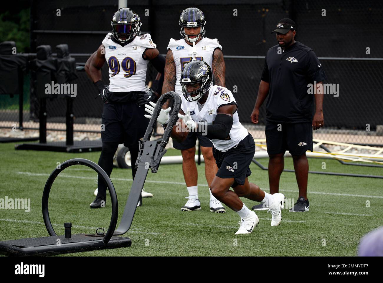 Baltimore Ravens linebacker Tyus Bowser, center, runs a drill during an ...