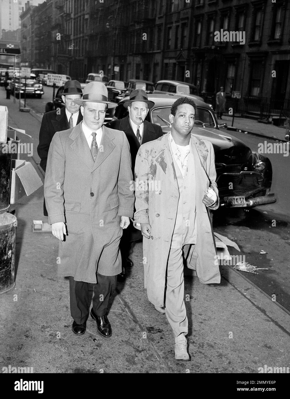 Clarence Sims, right, still wears blood-stained clothes as he is led ...