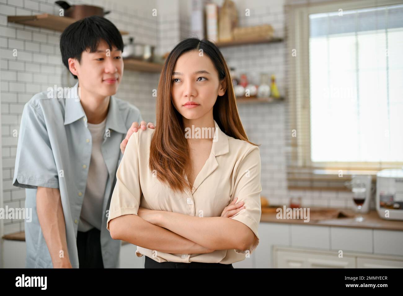 Caring and loving young Asian boyfriend is trying to comfort his angry ...