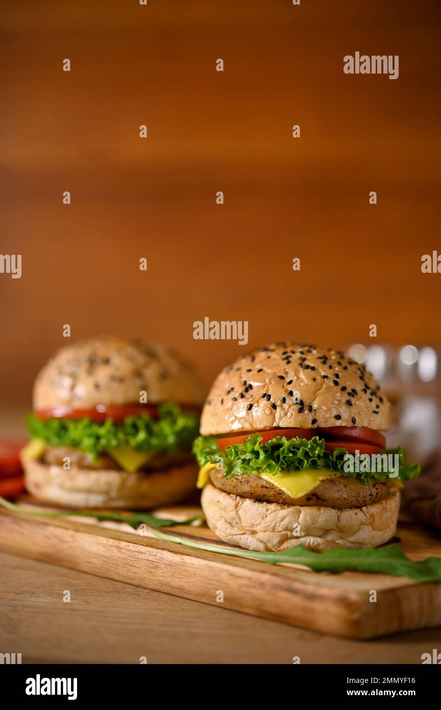 Tasty juicy beef burgers on wooden tray. Beef burger with cheese ...
