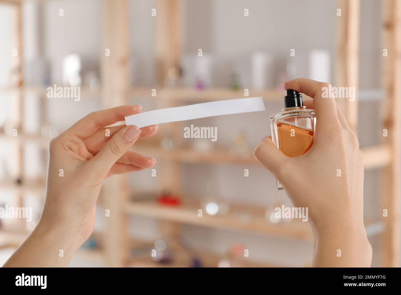 Woman spray perfume tester hi-res stock photography and images - Alamy