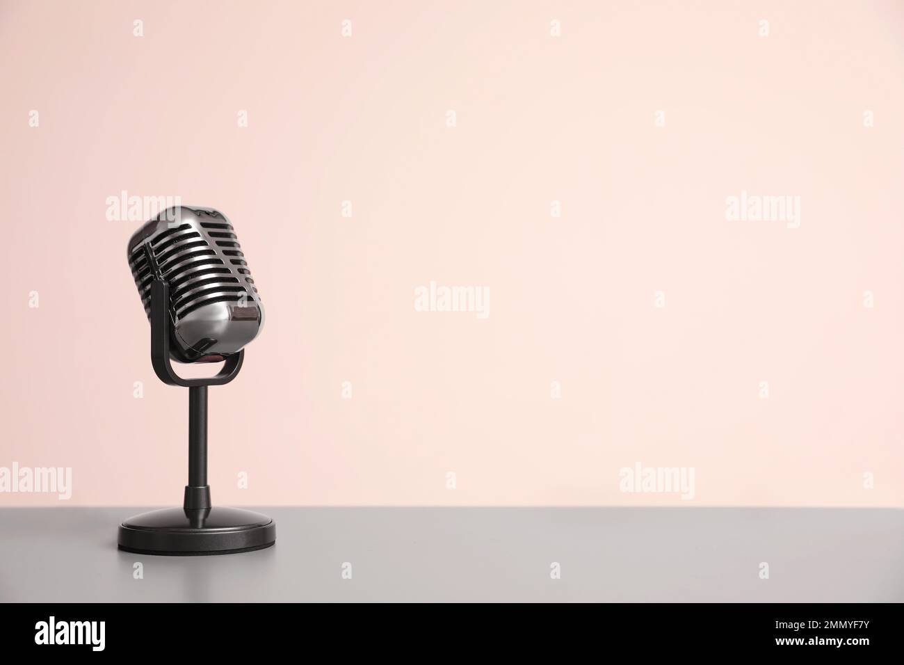 Vintage microphone on light grey table, space for text Stock Photo - Alamy