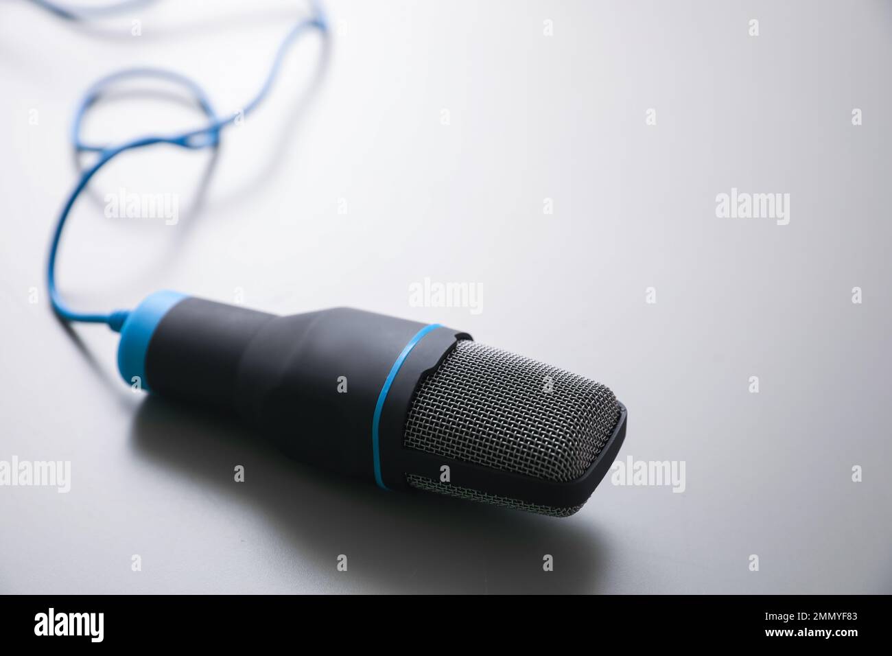 Microphone on light grey background. Journalist's work Stock Photo - Alamy