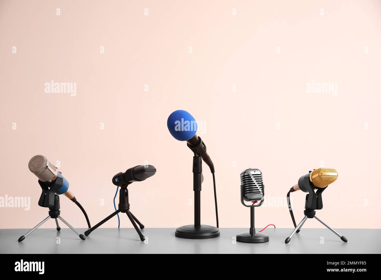 Different microphones on light grey table. Journalist's work Stock ...