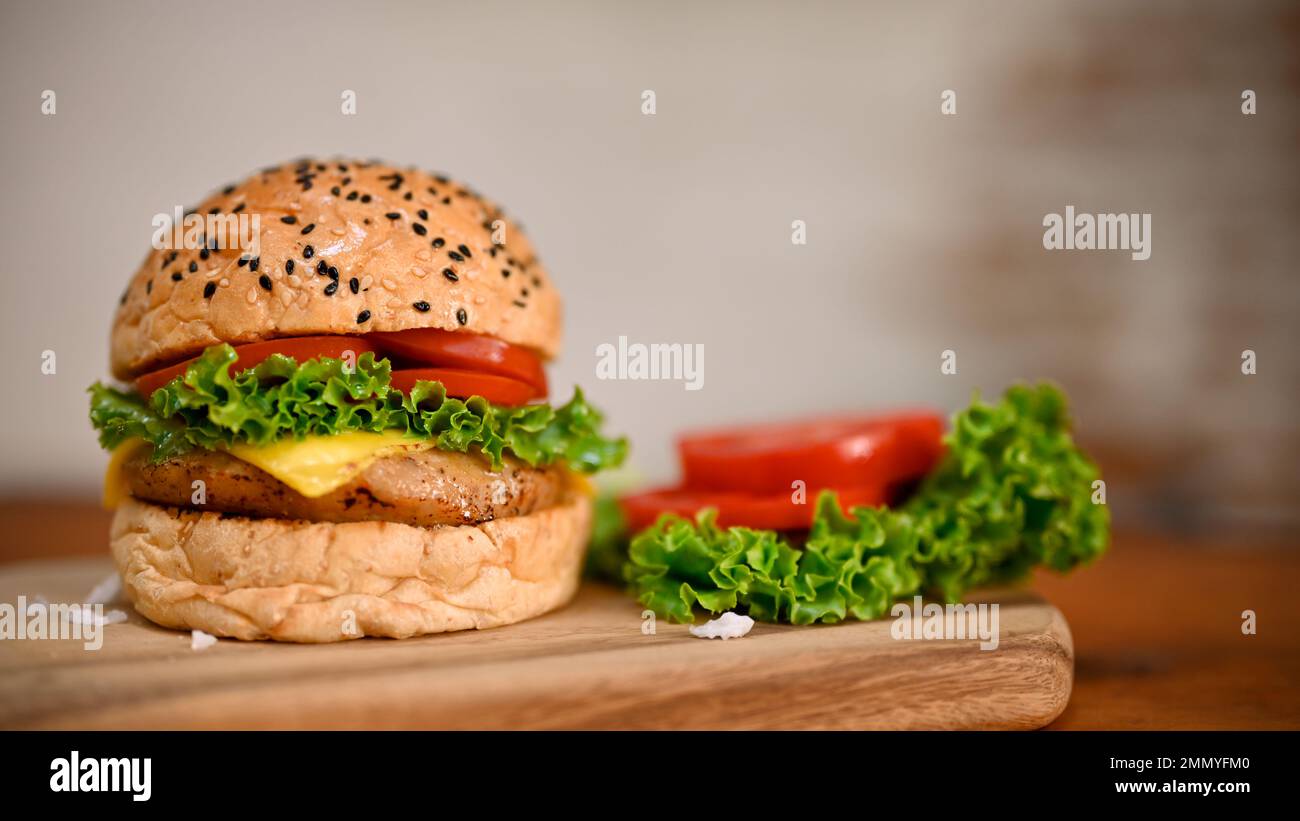 Delicious beef burger with tomato slides and lettuce on wooden rustic ...