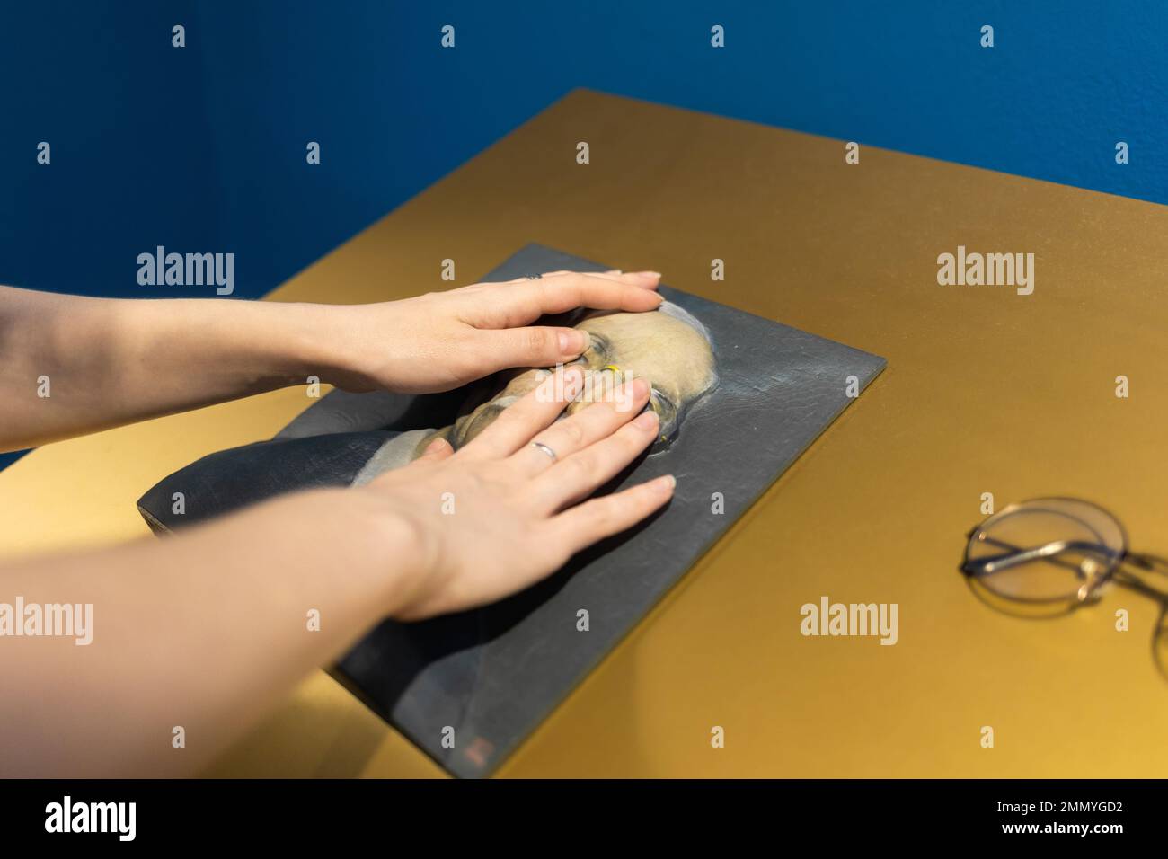 Woman's hands touches exposition in museum. Convex exhibit for visually ...