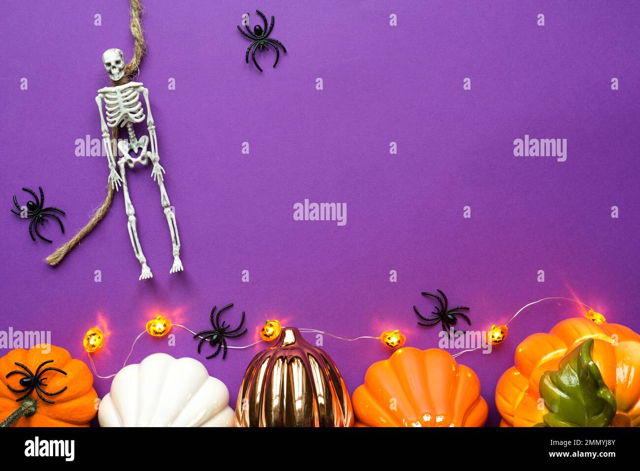 Halloween layout of garland of skeleton on a rope, glowing Jack o ...