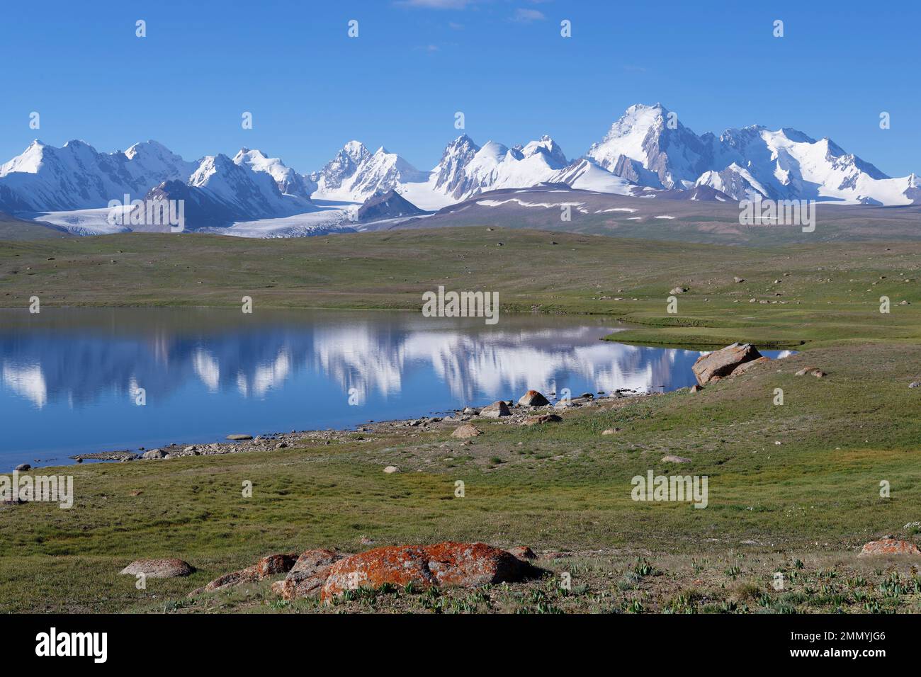 Kakshaal Too mountains reflecting in an alpine lake, Tian Shan mountain ...