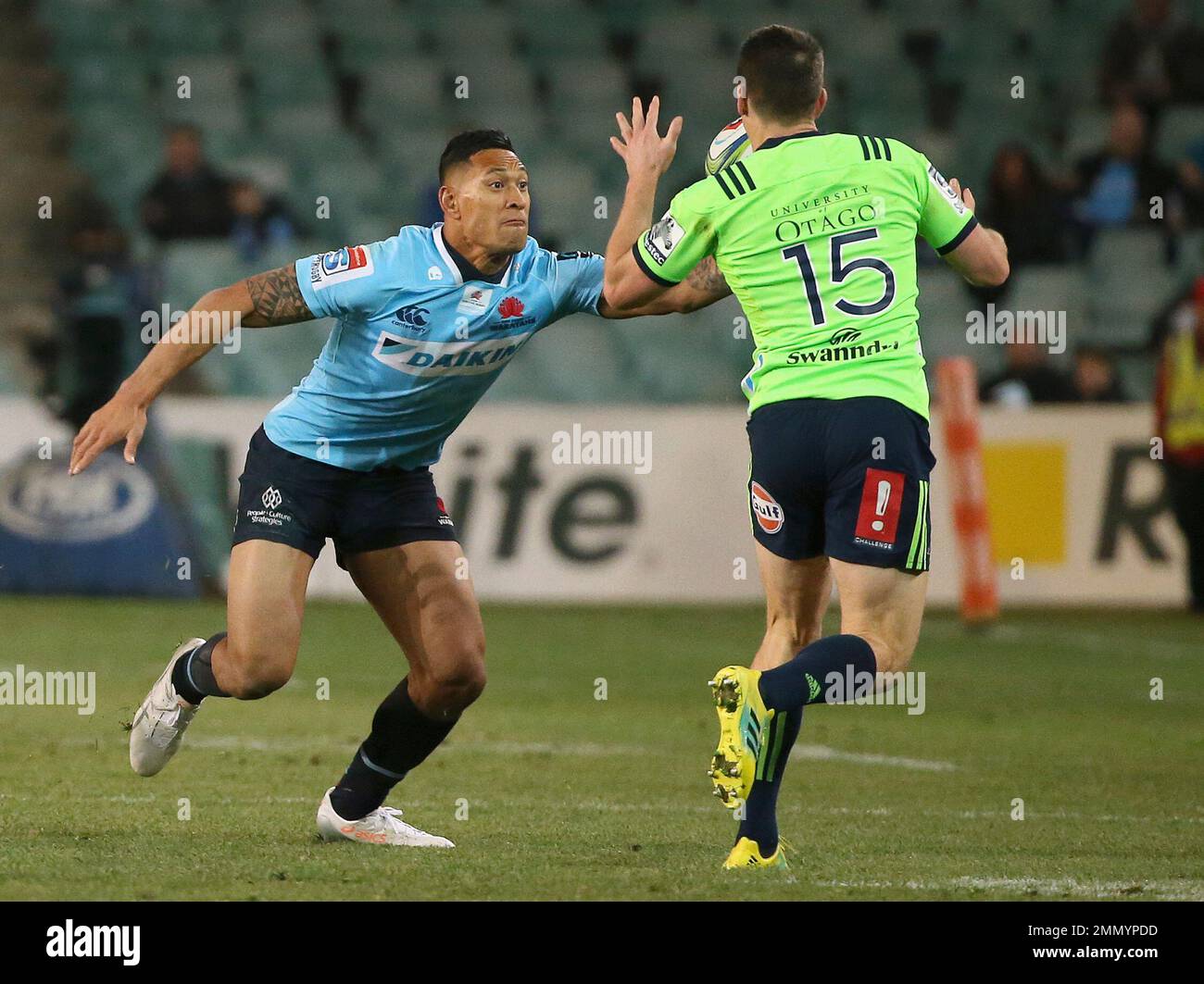 Highlanders' Ben Smith, right, steps past Waratahs' Israel Folau during ...