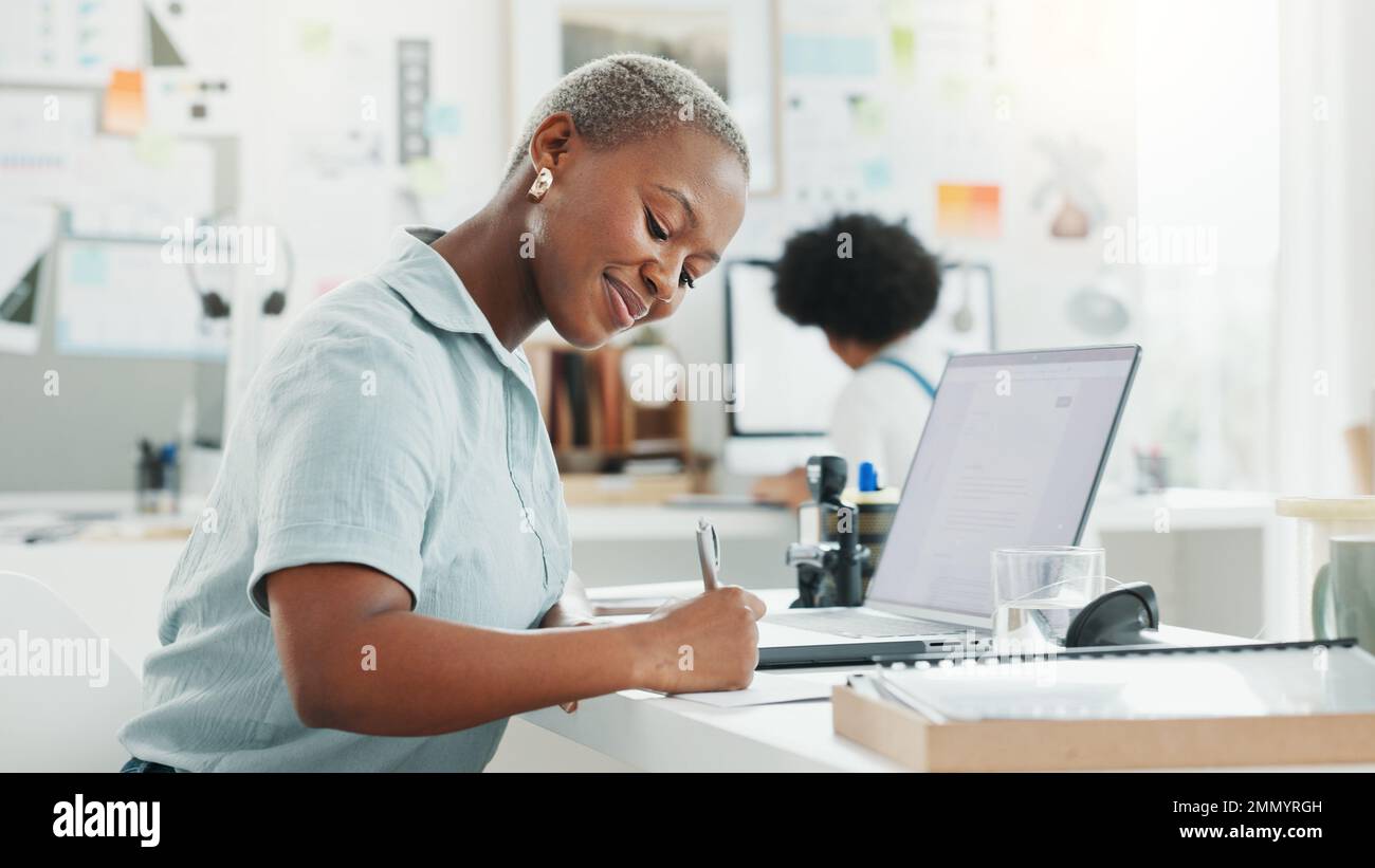 Black woman receptionist, writing notes or letter with laptop on table ...