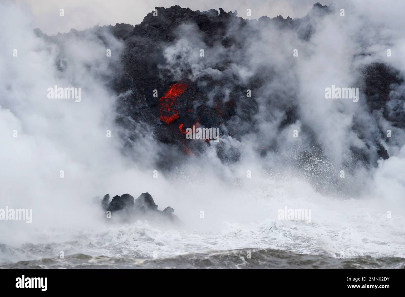 FILE - In this May 20, 2018 file photo, steam rises as lava flows into ...