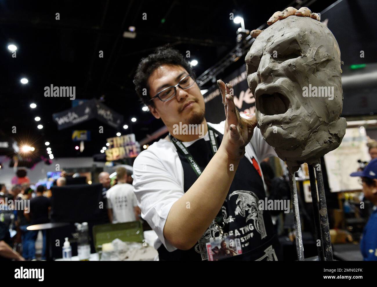 Sculptor Sam Gao works on a clay model during Preview Night of the 2018 ...