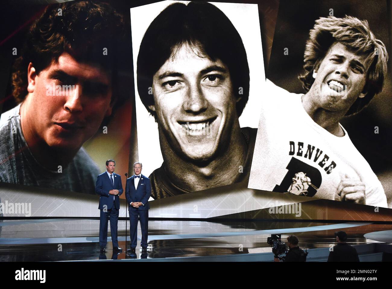 Dan Marino, left, and John Elway present the Jimmy V award for ...