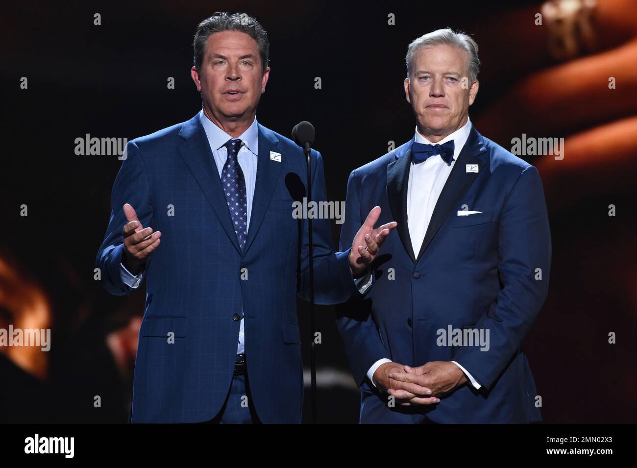 Dan Marino, left, and John Elway present the Jimmy V award for ...
