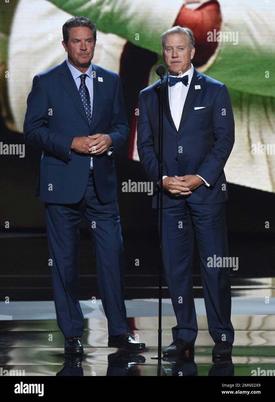 Dan Marino, left, and John Elway present the Jimmy V award for ...