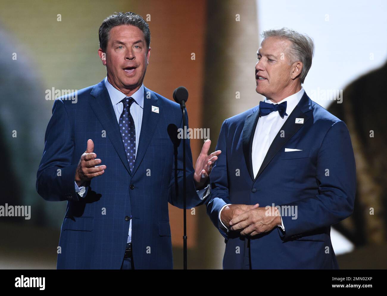 Dan Marino, left, and John Elway present the Jimmy V award for ...