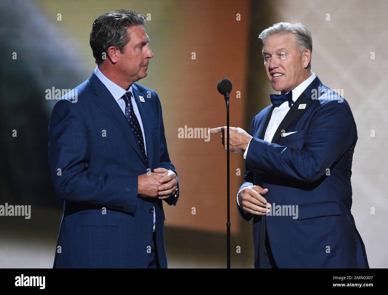 Dan Marino, left, and John Elway present the Jimmy V award for ...